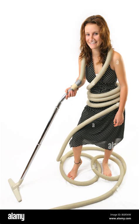 Young Woman Homemaker Tangled In Long Central Vacuum Cleaner Hose On