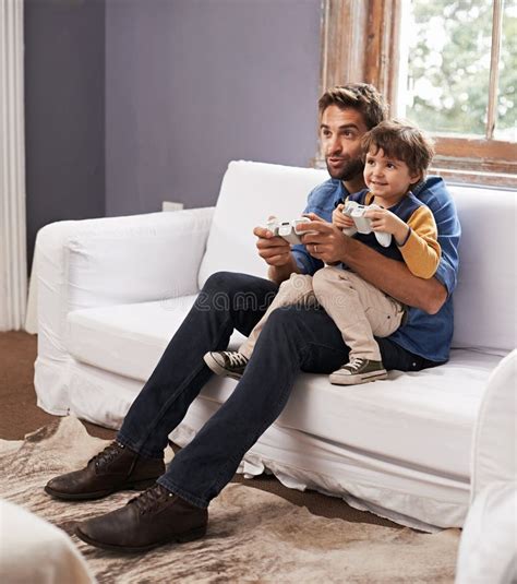 Love Father And Son On A Couch Video Game And Bonding At Home