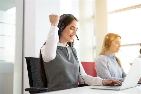 premium photo exited call center operator woman working on laptop and