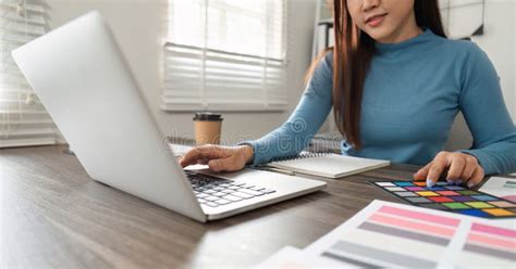 Creativity And Color Selection A Designer Analyzing Color Palettes While Working On A Laptop In