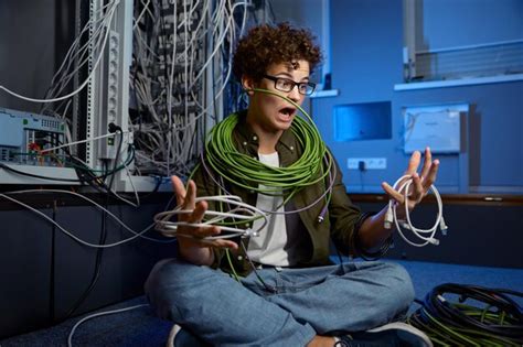 Premium Photo Shocked Teenager Geek Wrapped In Wire Sitting On Floor