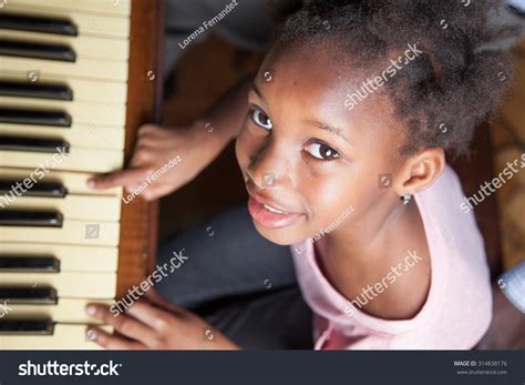 Young Girl Playing An Electronic Piano Keyboard Stock