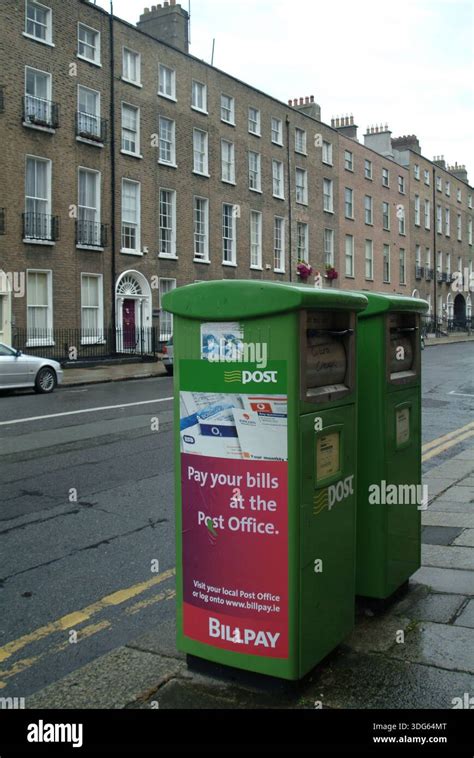 A Traditional Green Irish Post Box Standing Alone On A Quiet Dublin