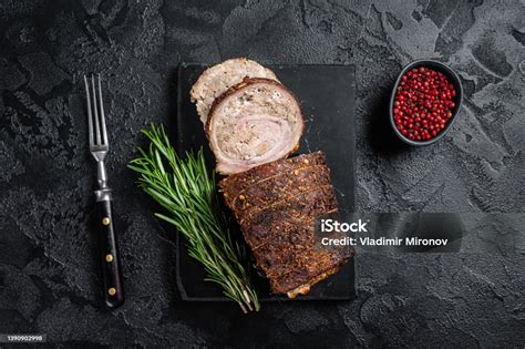 구운 돼지고기 룰라드 포르쉐타 허브가 있는 대리석 보드에 돼지고기 를 굴렸다 검은 색 배경 위쪽 보기 검은색에 대한 스톡 사진 및 기타 이미지 Istock