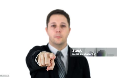 Businessman In Black Suit Pointing Index Finger Towards Camera Focus On The Hand And Finger