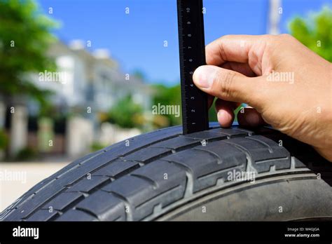 Checking The Depth Of Car Tire Tread Stock Photo Alamy