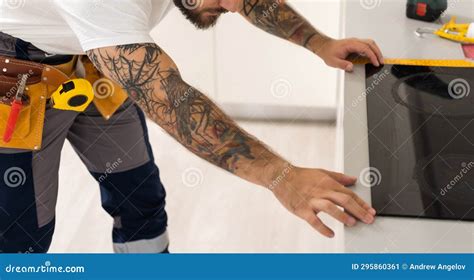 Man Sets Hob In Kitchen Installation An Induction Hob Above Oven Work In Accordance With