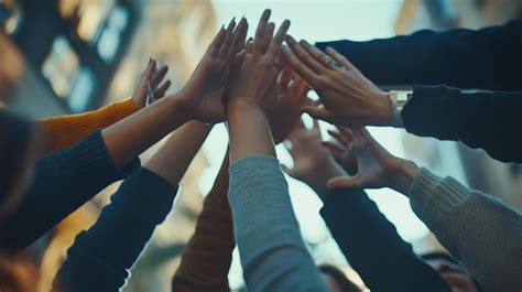 A Group Of Professionals Collaborating By Uniting Their Hands To Symbolize Teamwork And Unity In