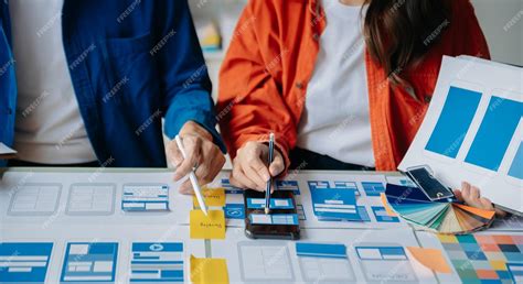 Premium Photo Ux Developer And Ui Designer Brainstorming About Mobile
