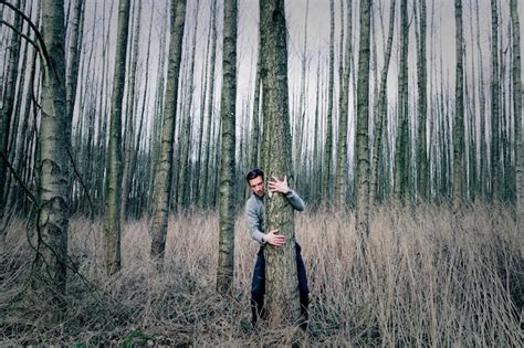 Premium Photo Man Hugging Tree In Forest