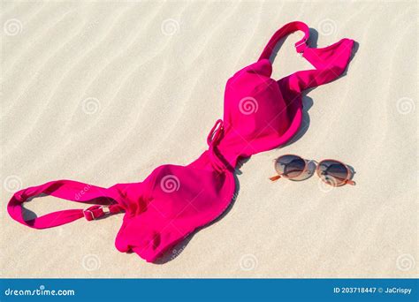 Close Up Of Woman Bra And Glasses On The Sand Concept Of Sunbathing