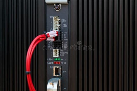 programmable logic controller with red cable connecting to input output