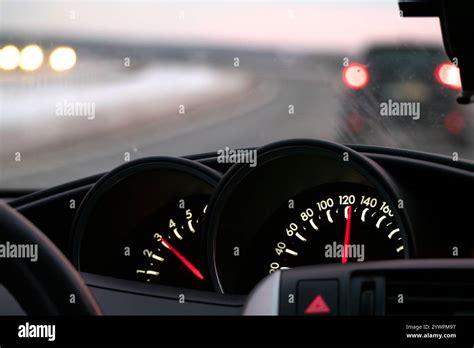 Close Up Of Car Speedometer With Blurred Road In Background Motion Speed And Travel On A Close Up Of Car Speedometer With Blurred Road In Background Motion Speed And Travel On A