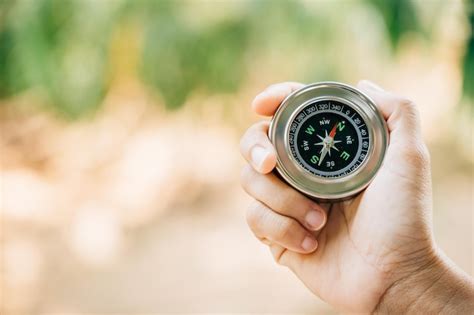 Premium Photo Traveler Holds A Compass In A Park Finding Her Way