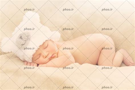 عکس با کیفیت کودک ناز خوابیده روی تخت با پتوی نرم عکس با کیفیت و