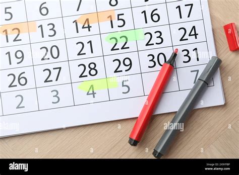 Timetable Calendar Page With Marked Dates And Felt Pens On Wooden