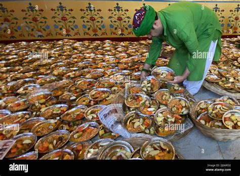 A Man Arrange Food Refreshment For Pilgrims During Muharram Inside The Shrine Of Sufi Saint