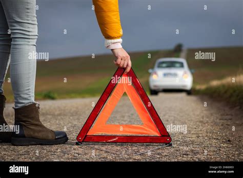 Woman Putting Warning Triangle On Road Because Car Is Broken Safety Red Road Warning Sign