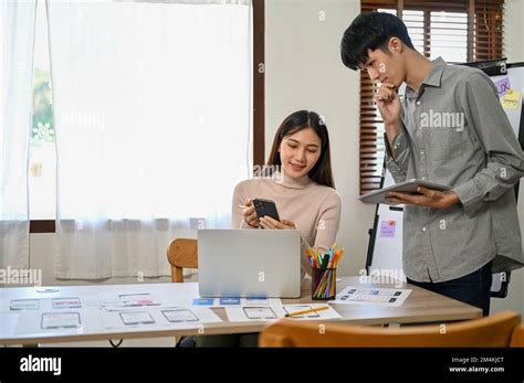 Professional Millennial Asian Male And Female Developers Are In The