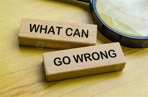 Top View Of What Can Go Wrong Text On Wooden Blocks With Magnifying