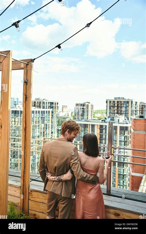 A Man And A Woman Stand Side By Side Exuding An Aura Of Unity And Connection As They Look Ahead