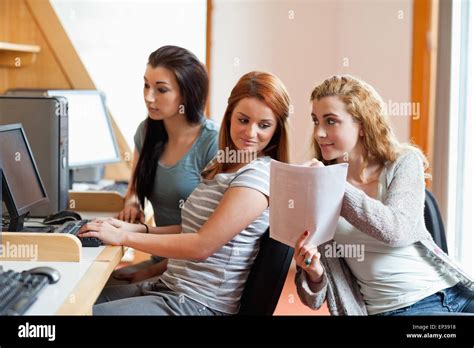 Cute Student Showing Her Notes To Her Classmate Stock Photo Alamy
