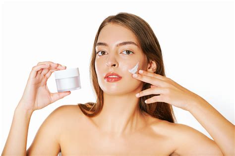 얼굴에 얼굴 크림을 적용 하는 젊은 아름 다운 여자의 이미지를 닫고 흰색 배경 보습제와 항아리를 들고 20 24세에 대한 스톡 사진 및 기타 이미지 Istock