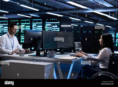 Person With Disability And Coworker In Inclusive Server Room Facility Ensuring Data Remains