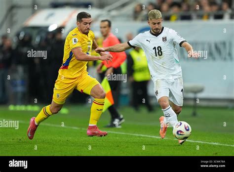 Austrias Romano Schmid Right Challenges For The Ball With Romanias
