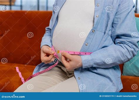 Pregnant Woman Measuring Belly Diameter With Measure Tape Awaiting