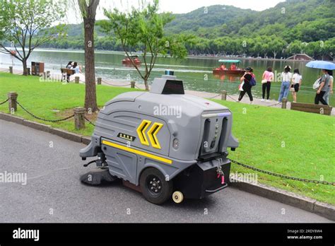 An Intelligent Sweeping Robot Works At The Bai Causeway In The West Lake Scenic Spot Drawing