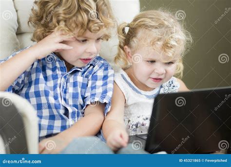 Young Brother And Sister Using Their Computer Laptop Together Stock Image