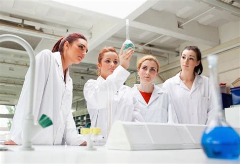 Science Babes Looking At A Liquid In A Flask Stock Photo Image Of Appearance Four