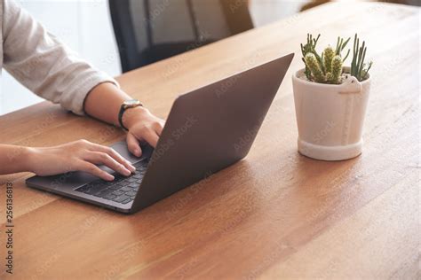 Closeup Image Of Woman S Hands Using And Typing On Laptop Keyboard On The Table Stock Photo