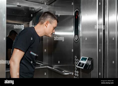 a man shows his face to a fingerprint access control terminal with a