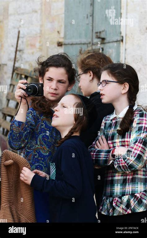 A Group Of Ultra Orthodox Jewish Girls Taking A Picture With A Camera