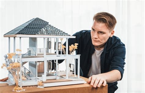 Premium Photo Architect Designer Reviewing House Frame Model With No