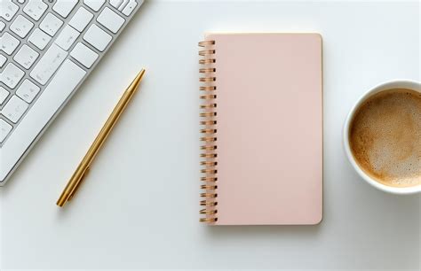 Workspace Setup Featuring A Notepad Coffee Cup And Keyboard For