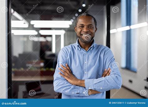 Confident African American Businessman Smiling With Arms Crossed In