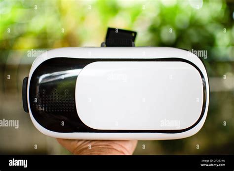 Male Hand Holding Virtual Reality VR White And Black Man VR Plays Alone Closeup Blurred