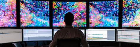 Big Data Revelation Analyst At A Workstation With Complex Data