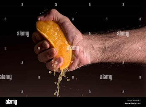 Hand squeezing orange juice hi-res stock photography and images - Alamy