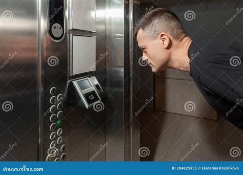 A Man Shows His Face To A Fingerprint Access Control Terminal With A Facial Recognition Function