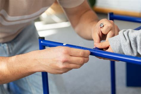 Son Helps Father Assemble Furniture Collaborative Assembly Of