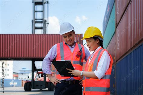 Asian Female Worker Is Explaining A Check List Of Container Inspections To The Supervisor In