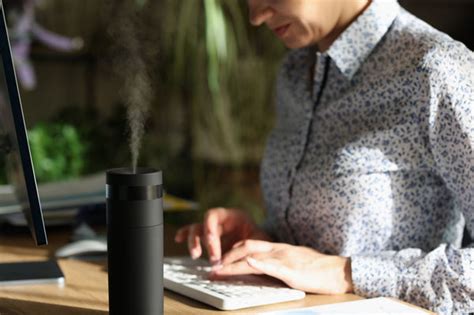 Woman At A Computer Researching And A Diffuser Operating In The Foreground