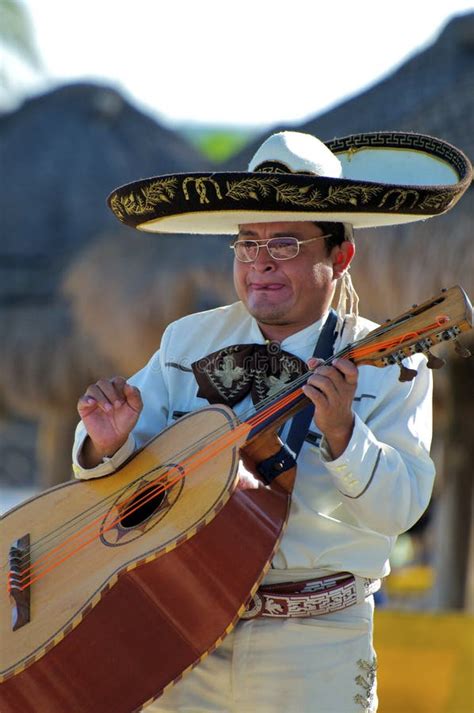 Portrait Of A Mariachi Player Performing With A Guitarron For A Beach