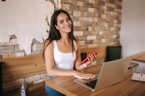 Premium Photo Attractive Girl Working On Laptop In Cafe Beautiful