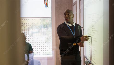 Teacher Leading Lesson At Projection Screen In Classroom Stock Image F028 4096 Science