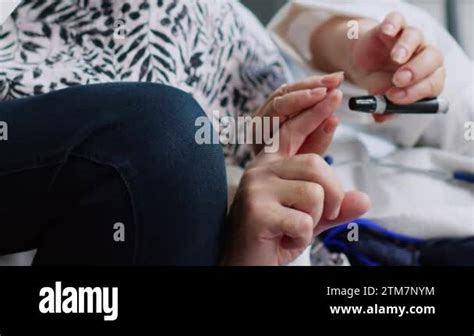 Vertical Video Elderly Medic Taking Insulin Level Test Using Glucometer In Hospital Reception